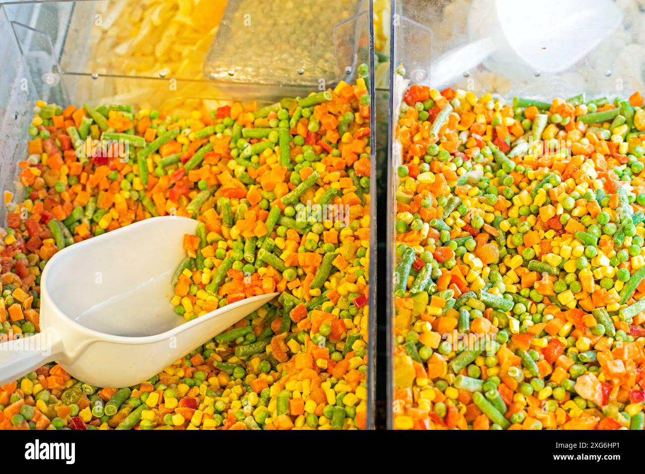 frozen vegetables weighed in a container in a supermarket. Healthy diet ...