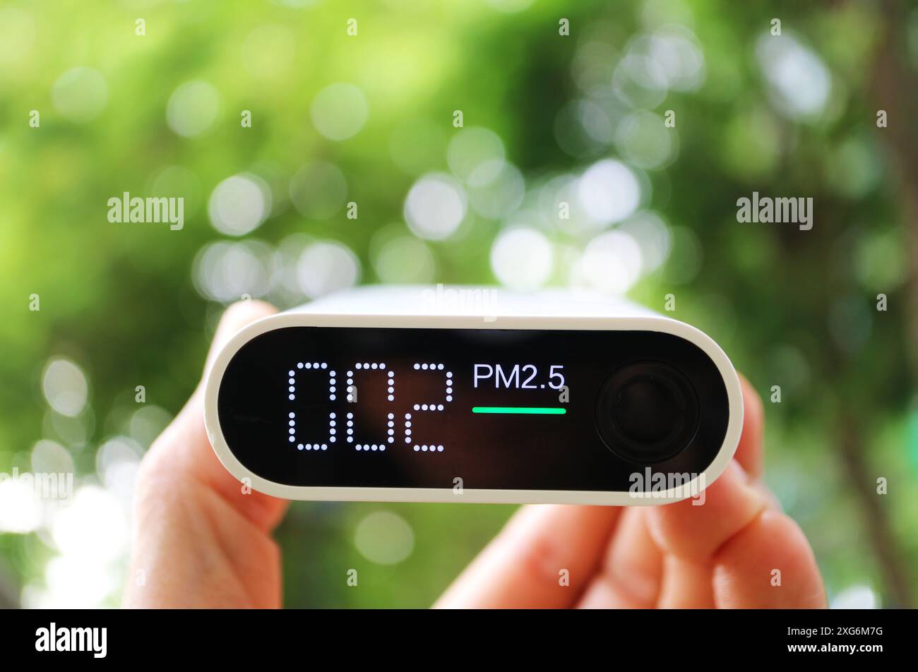 Hand holding an air pollution sensor measuring air quality in the ...