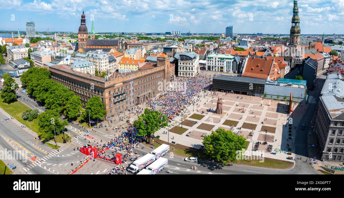 Aerial View of Marathon Runners in Riga with St. Peter's Church in ...