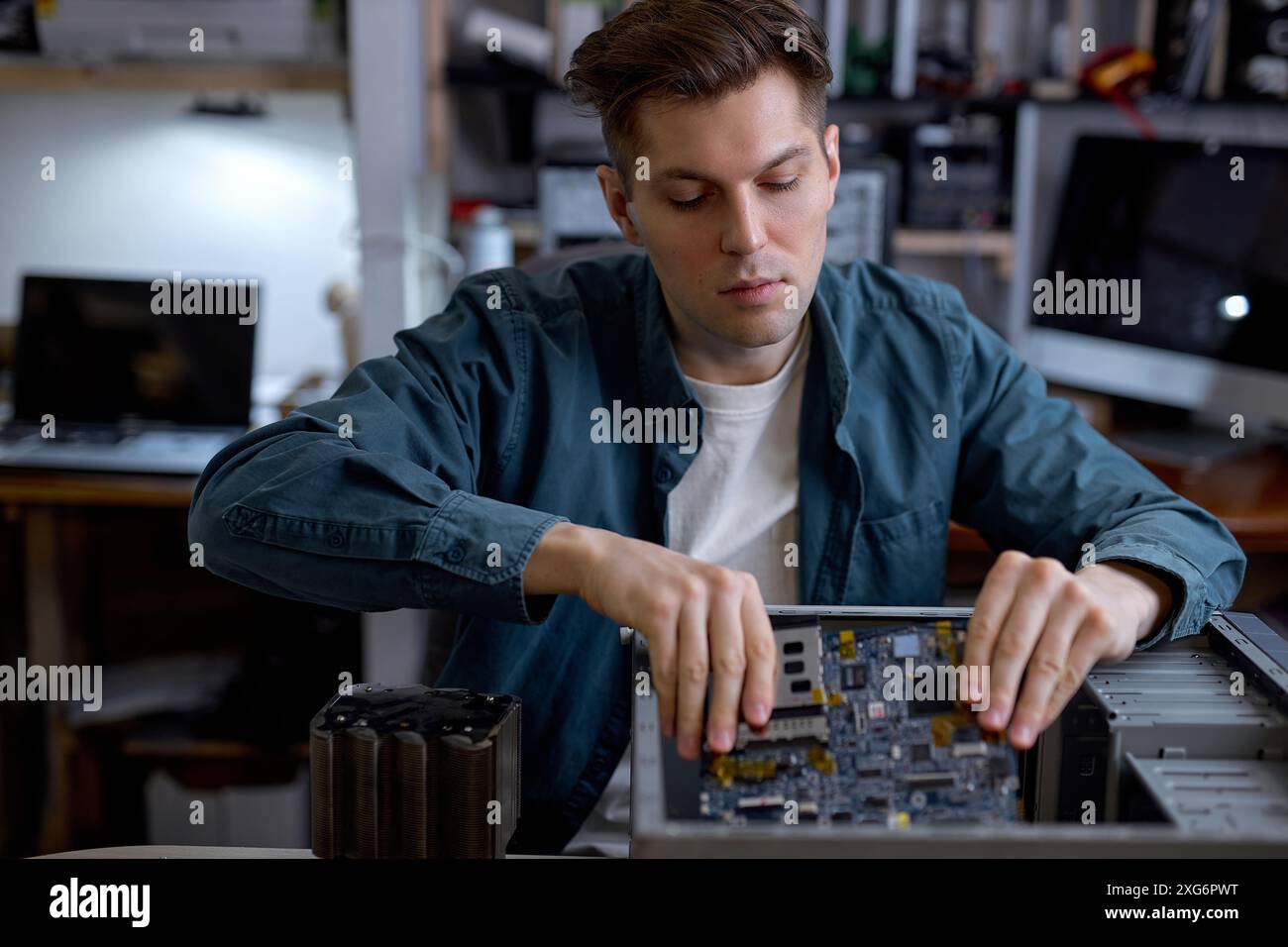 Person disassembles device motherboard in hi-res stock photography and ...