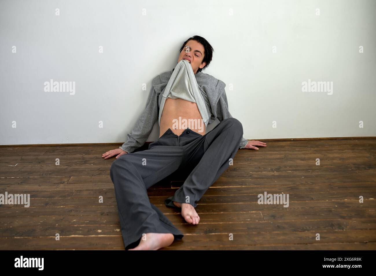 Young angry furious frustrated man sitting on the floor while shouting ...