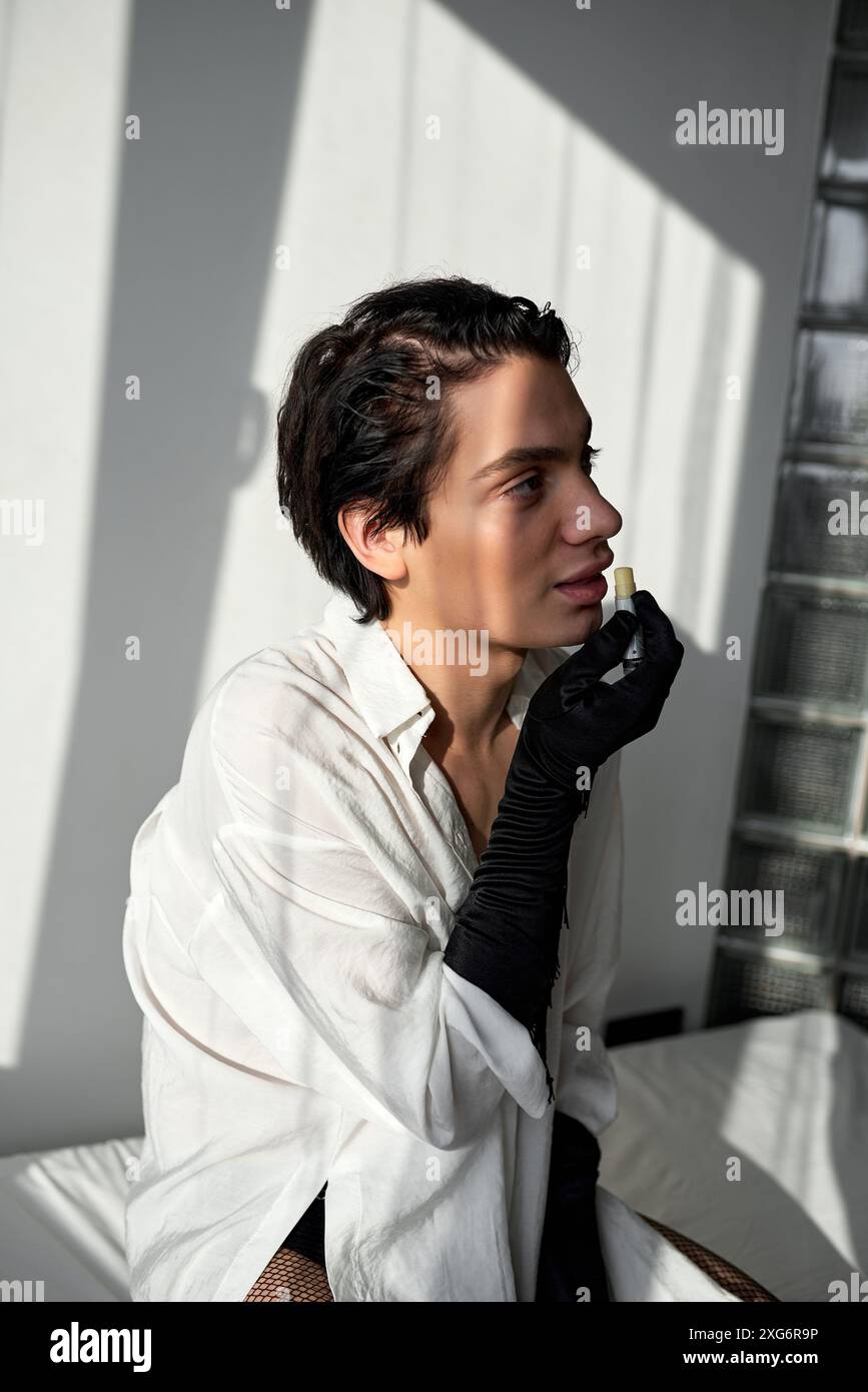 young actor using lipbalm before performance, close up side view ...