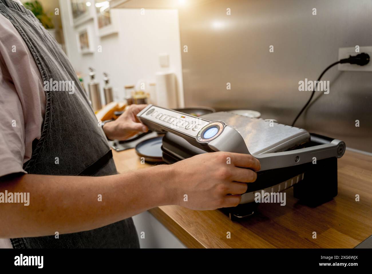 Chef cooking white bread toasted on an electric grill Stock Photo - Alamy