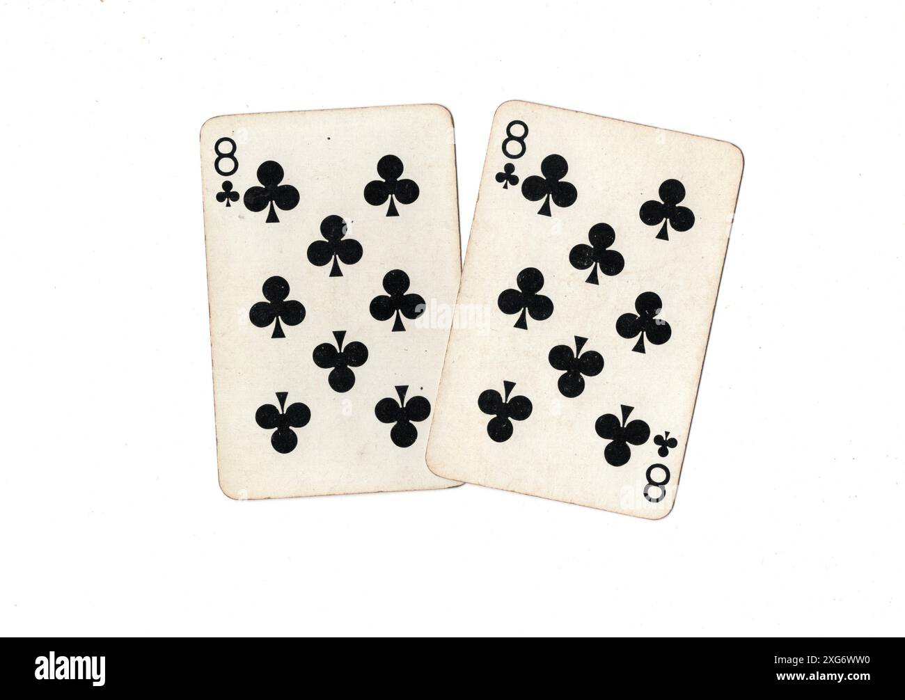 A pair of vintage eight of clubs playing cards on a white background ...
