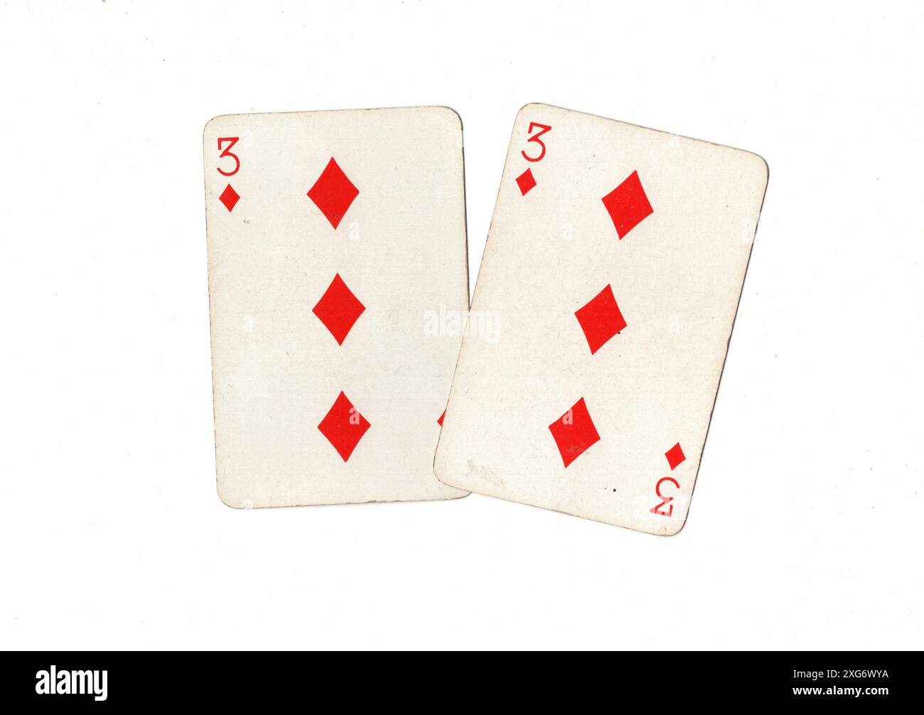 A pair of vintage three of diamonds playing cards on a white background ...