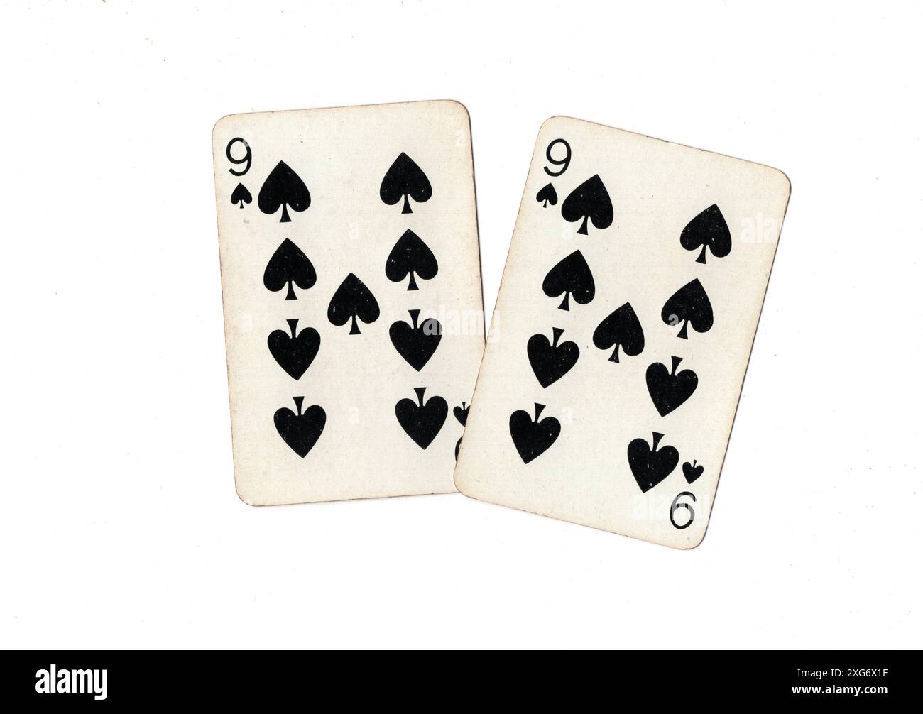 A pair of vintage nine of spades playing cards on a white background ...