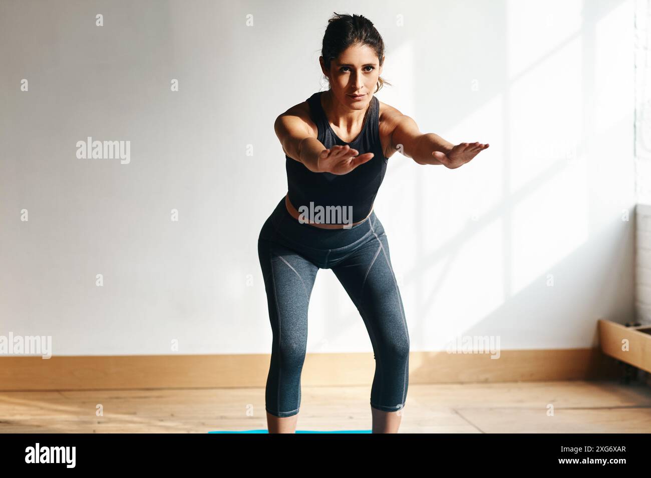Yoga, balance and routine of woman, squat and fitness in living room ...
