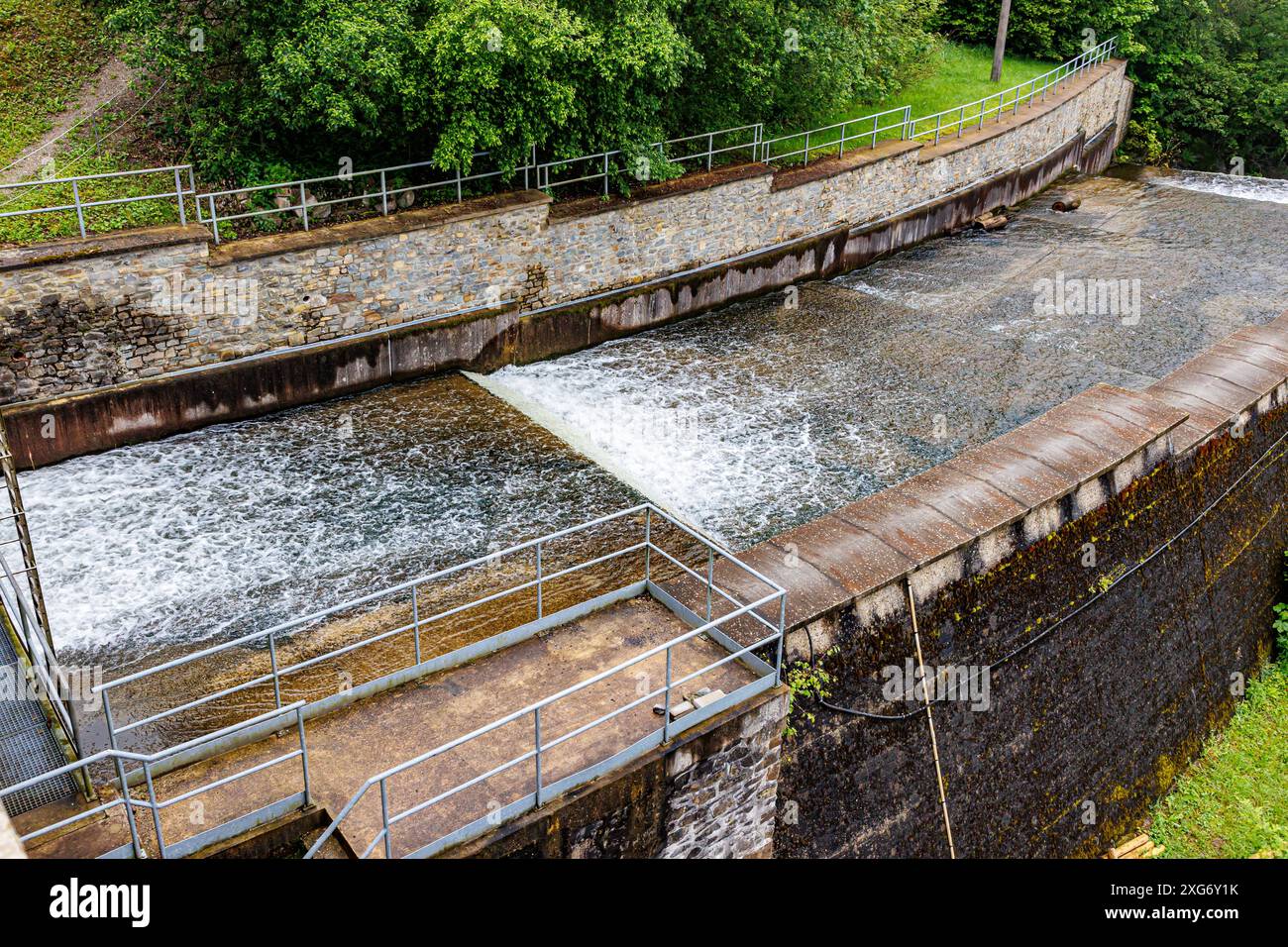 Stepped auxiliary spillway on Robertville Dam with water flowing into ...