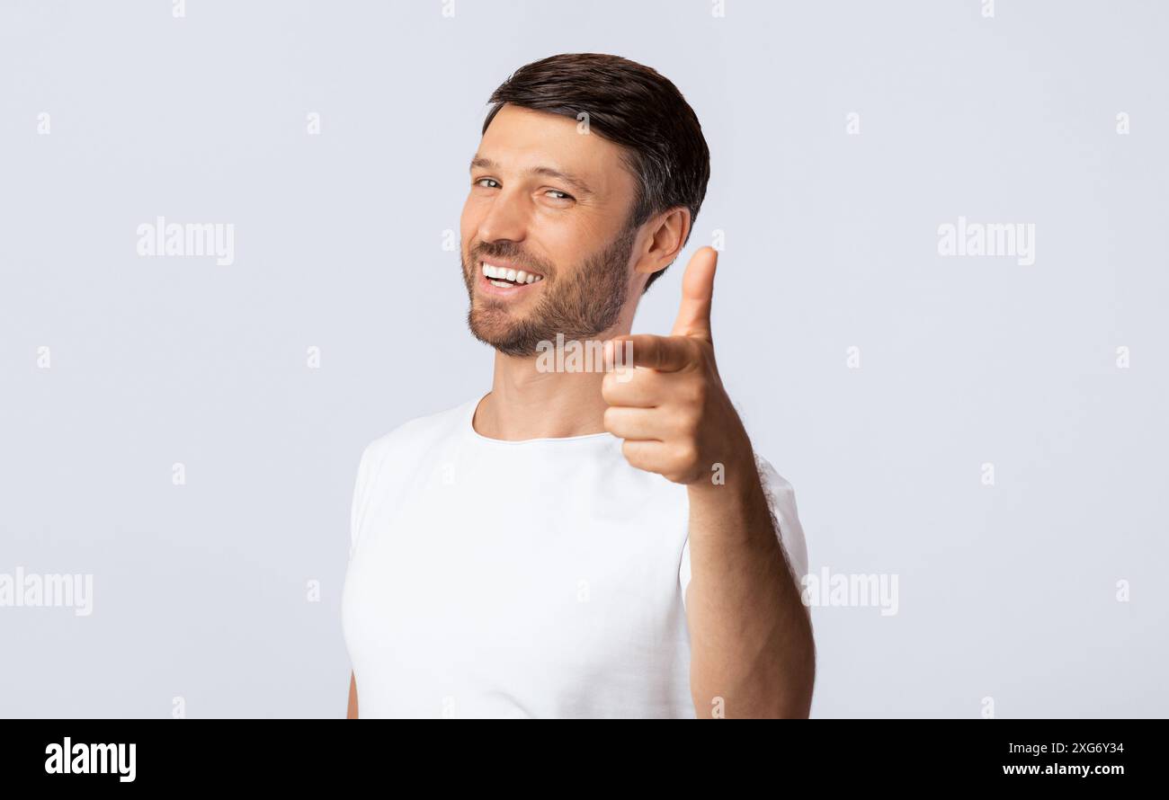Guy pointing finger at camera standing on white background Stock Photo ...