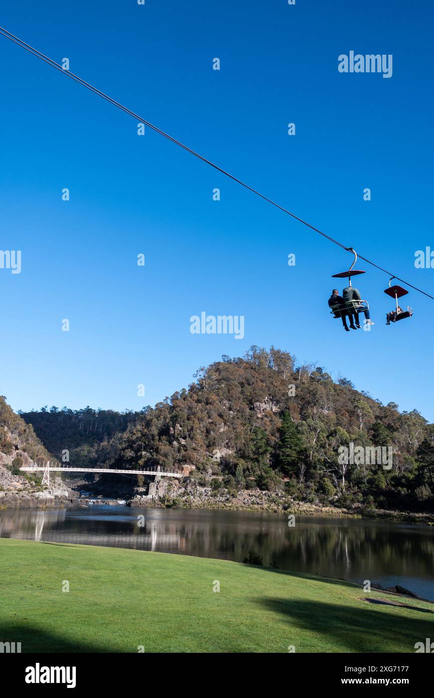 A chain of chair lifts crossing a lake with the Alexandra suspension ...