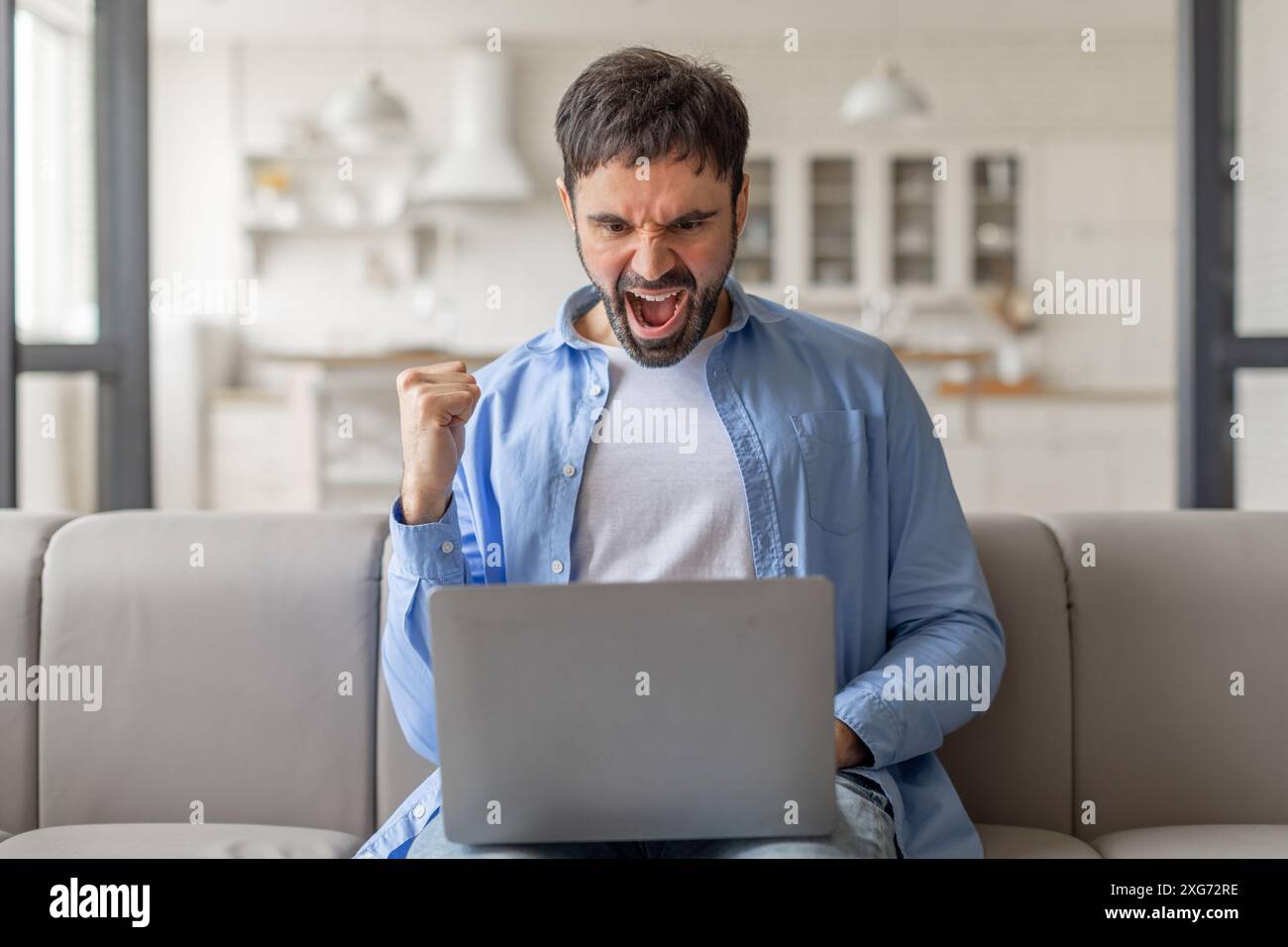 Millennial excited man celebrating success hi-res stock photography and ...