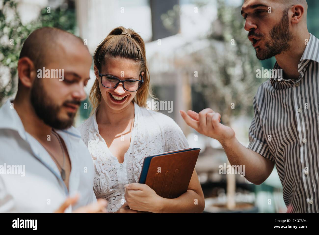 Business workers collaborating together on a project in a coffee bar ...