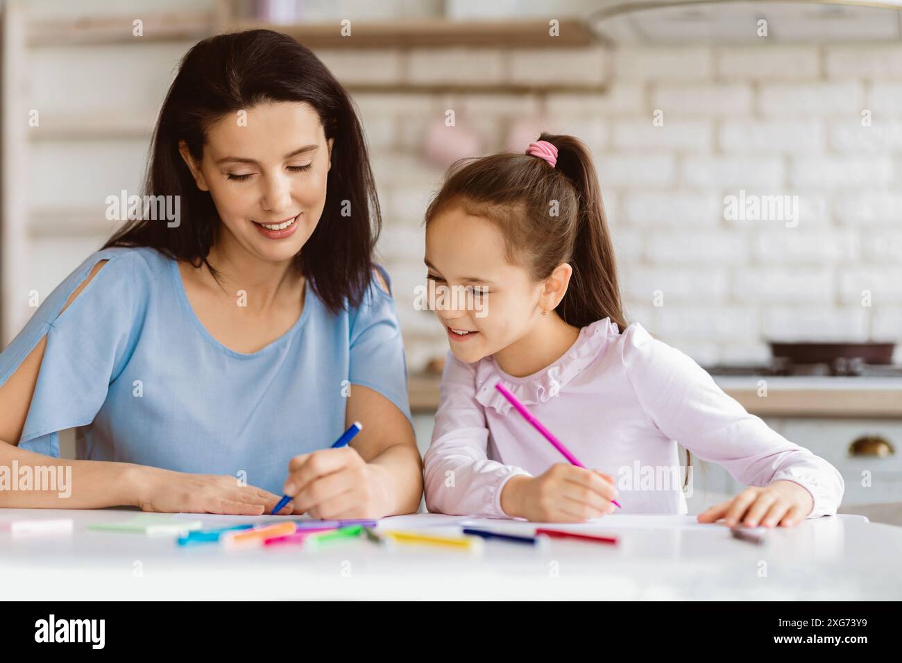 Mother and Daughter Coloring Together in a Kitchen Setting Stock Photo ...