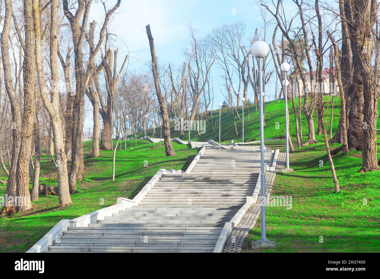 Park with a long path that leads to a hill. Stairs ascending to hilltop ...