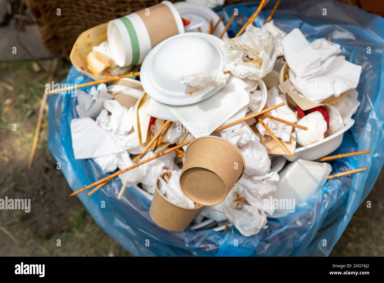Close-up view of full garbage bin can with used dirty paper cardboard ...
