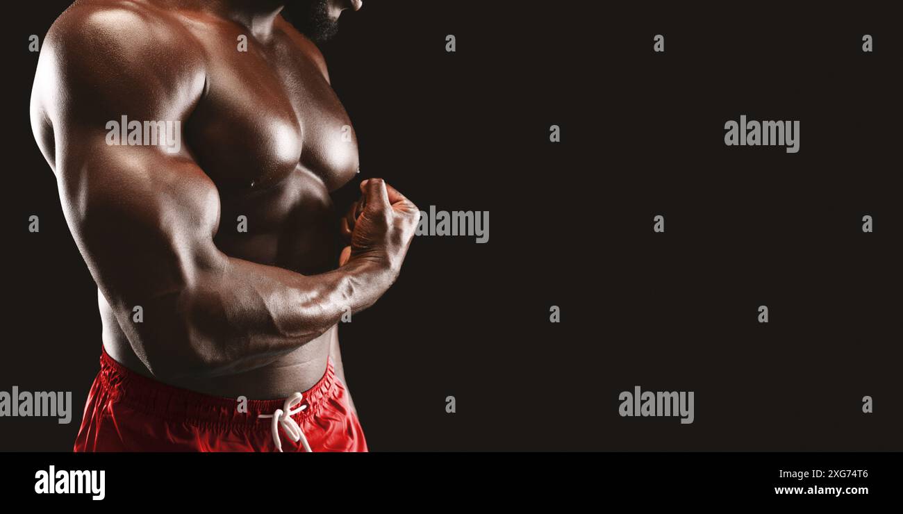 Muscular Man Flexing Biceps Against Black Background Stock Photo - Alamy