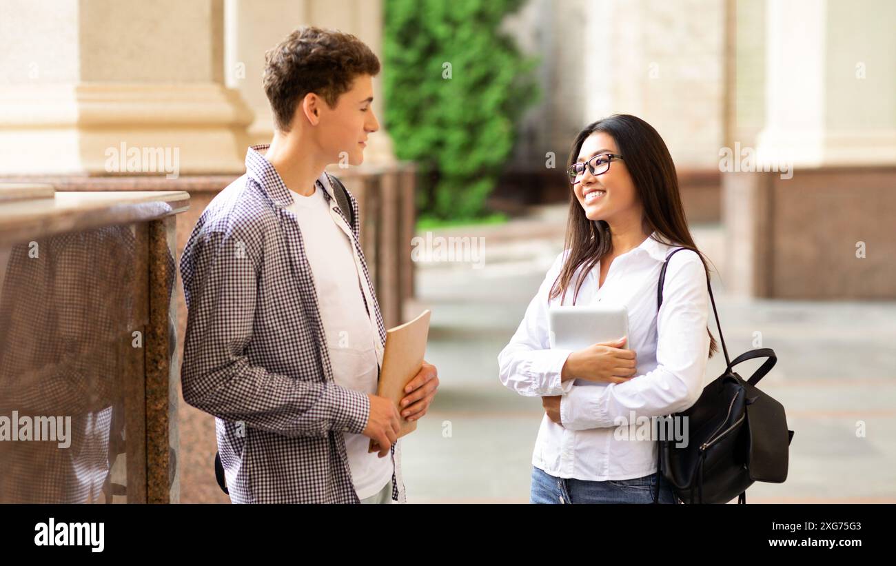 Student couple having break after classes and flirting Stock Photo - Alamy
