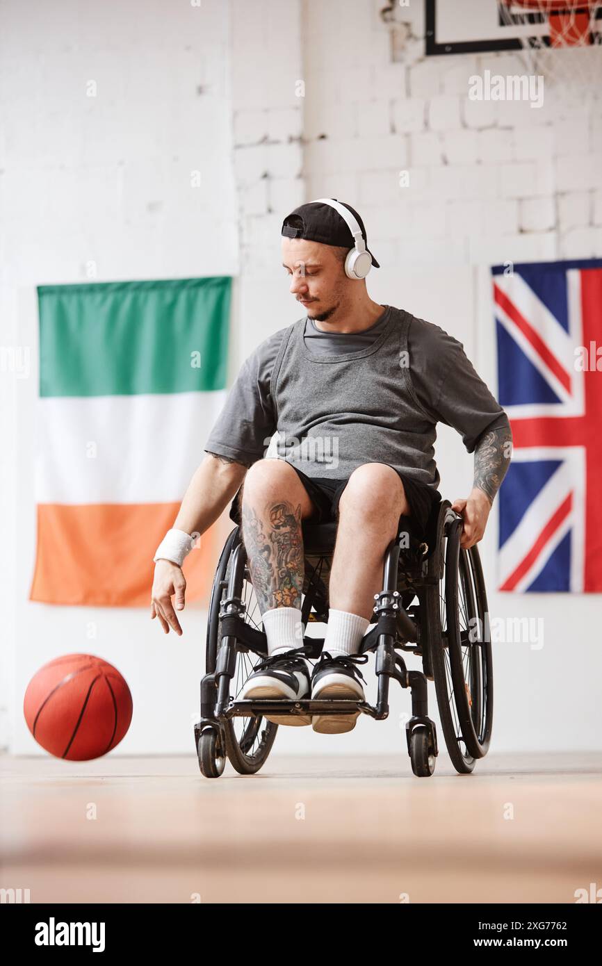 Vertical full length portrait of sportsman with disability playing ...