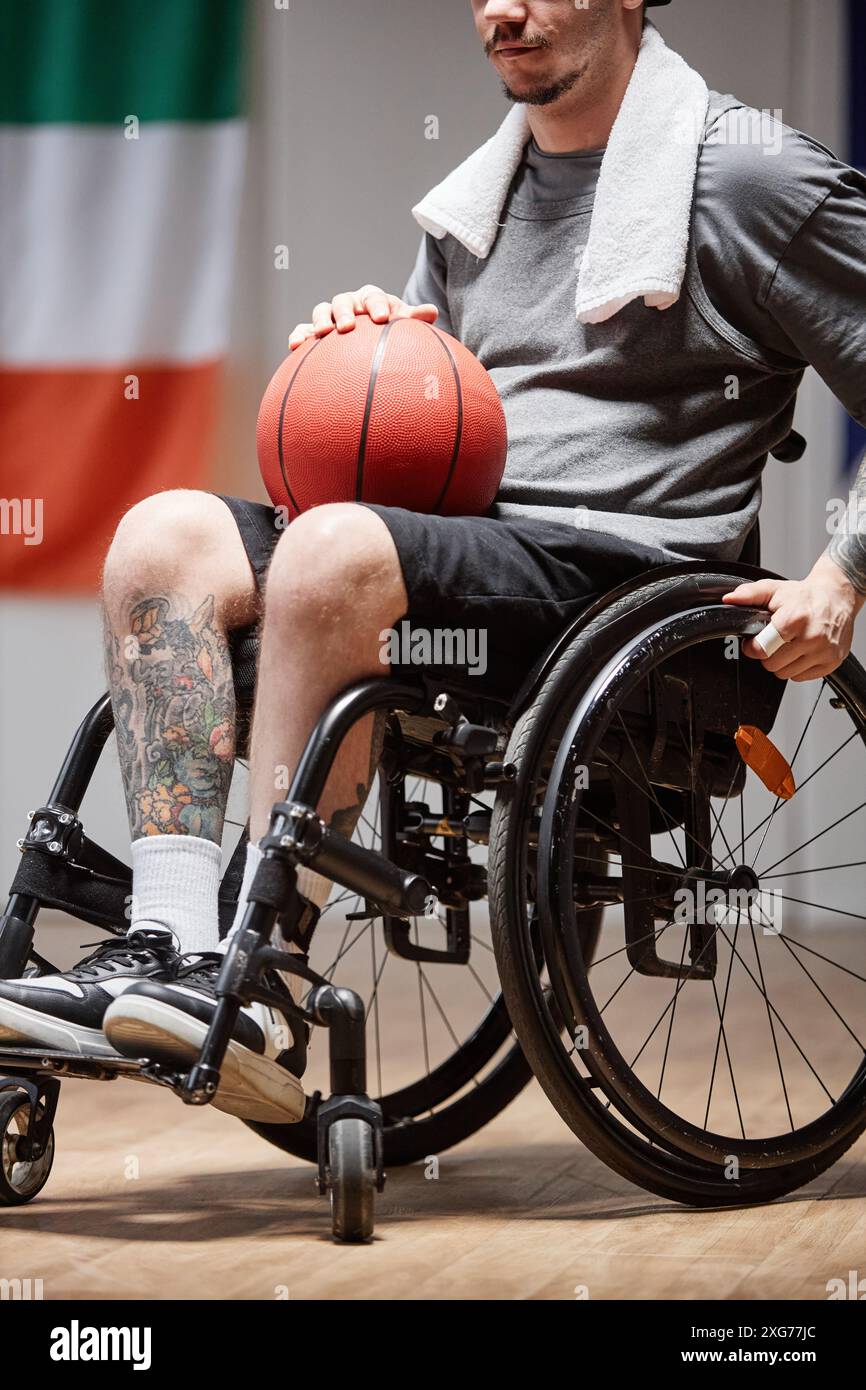 Vertical cropped shot of tattooed sportsman with disability using ...