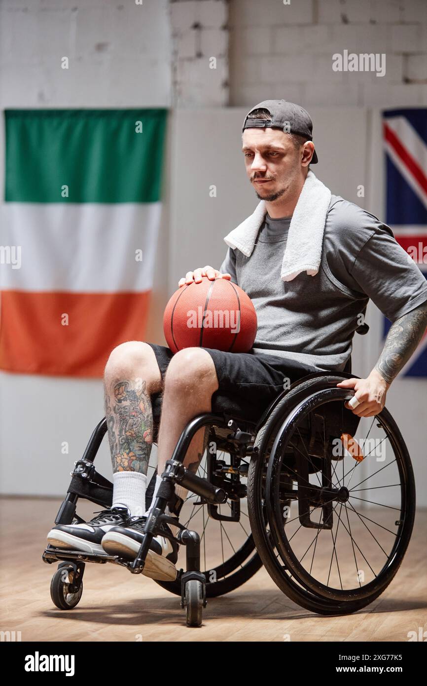 Vertical full length portrait of tattooed basketball player with ...