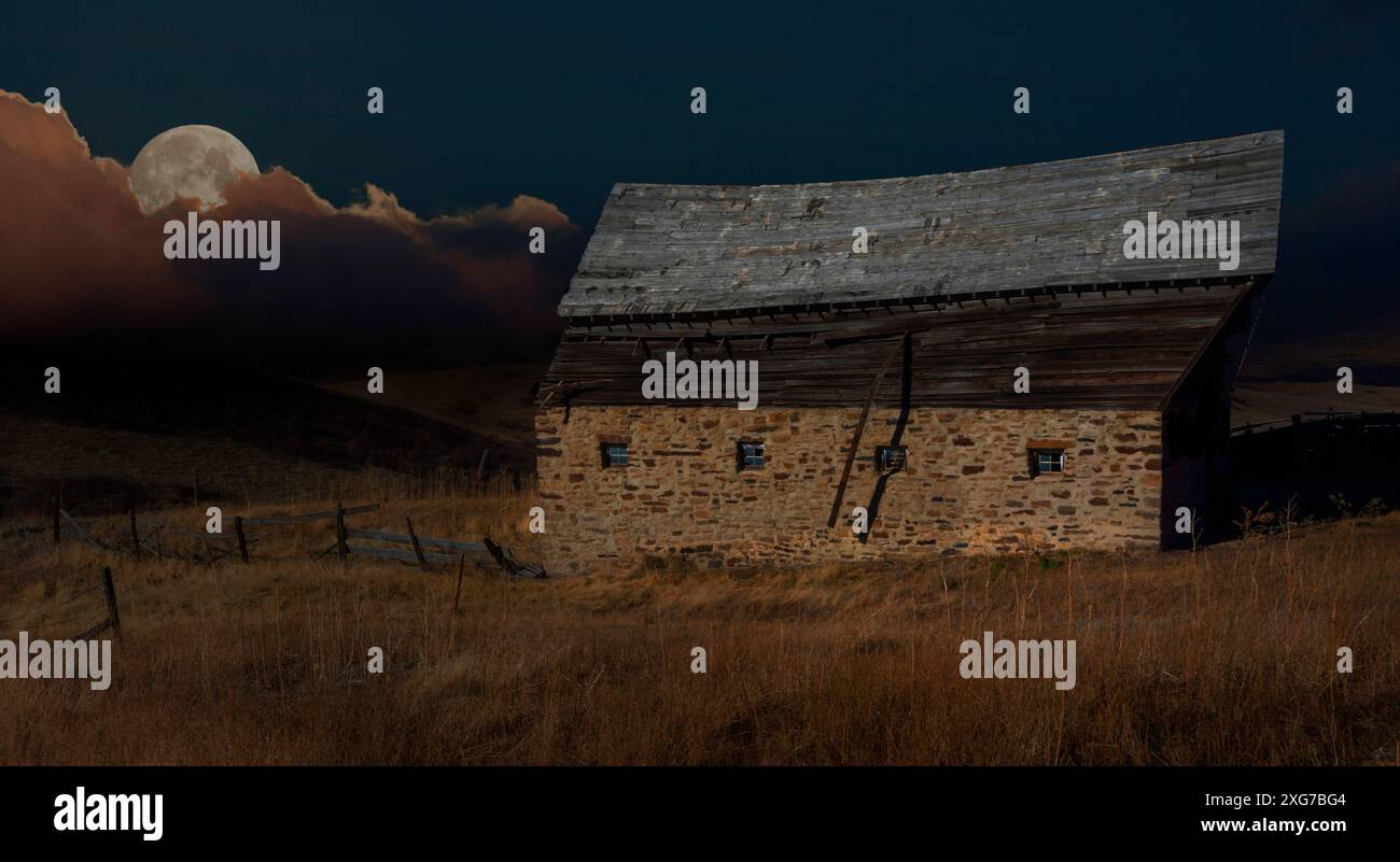 Full moon rising above clouds on the horizon in hilly country over an ...