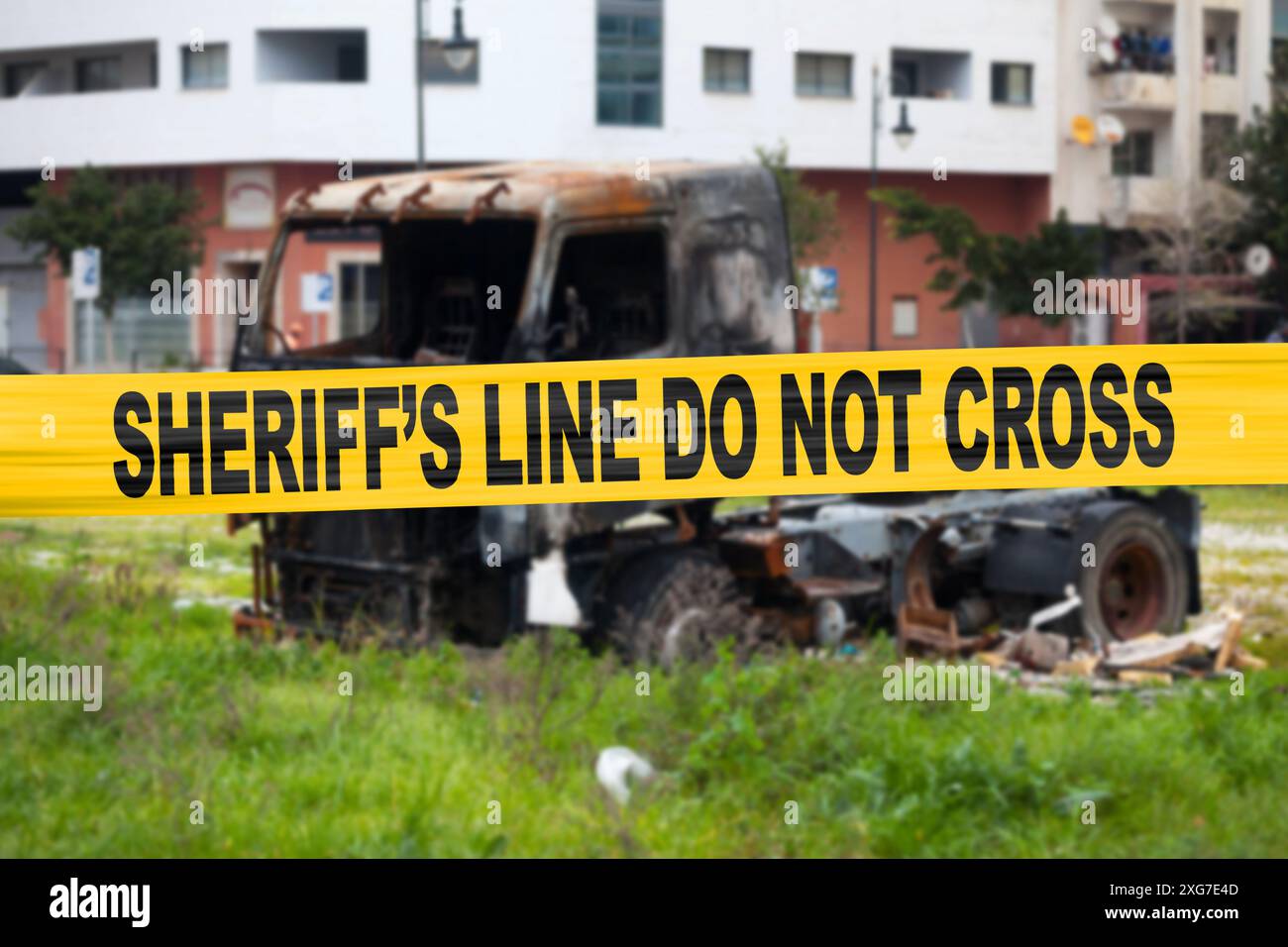 Truck burnt by a pyromaniac with a police tape with written in it ...