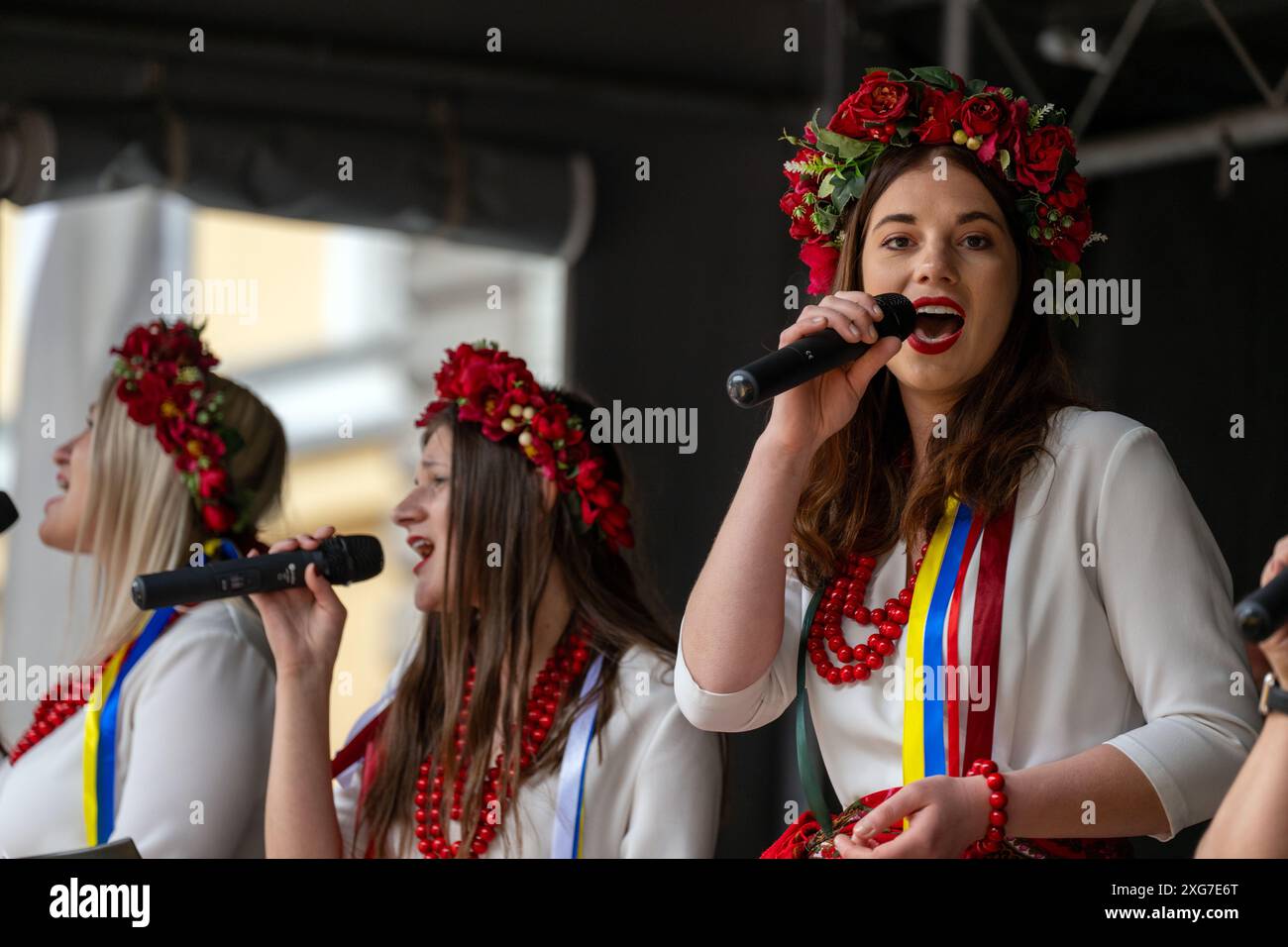 07 July 2024, Bavaria, Wunsiedel: With red flower wreaths and white ...