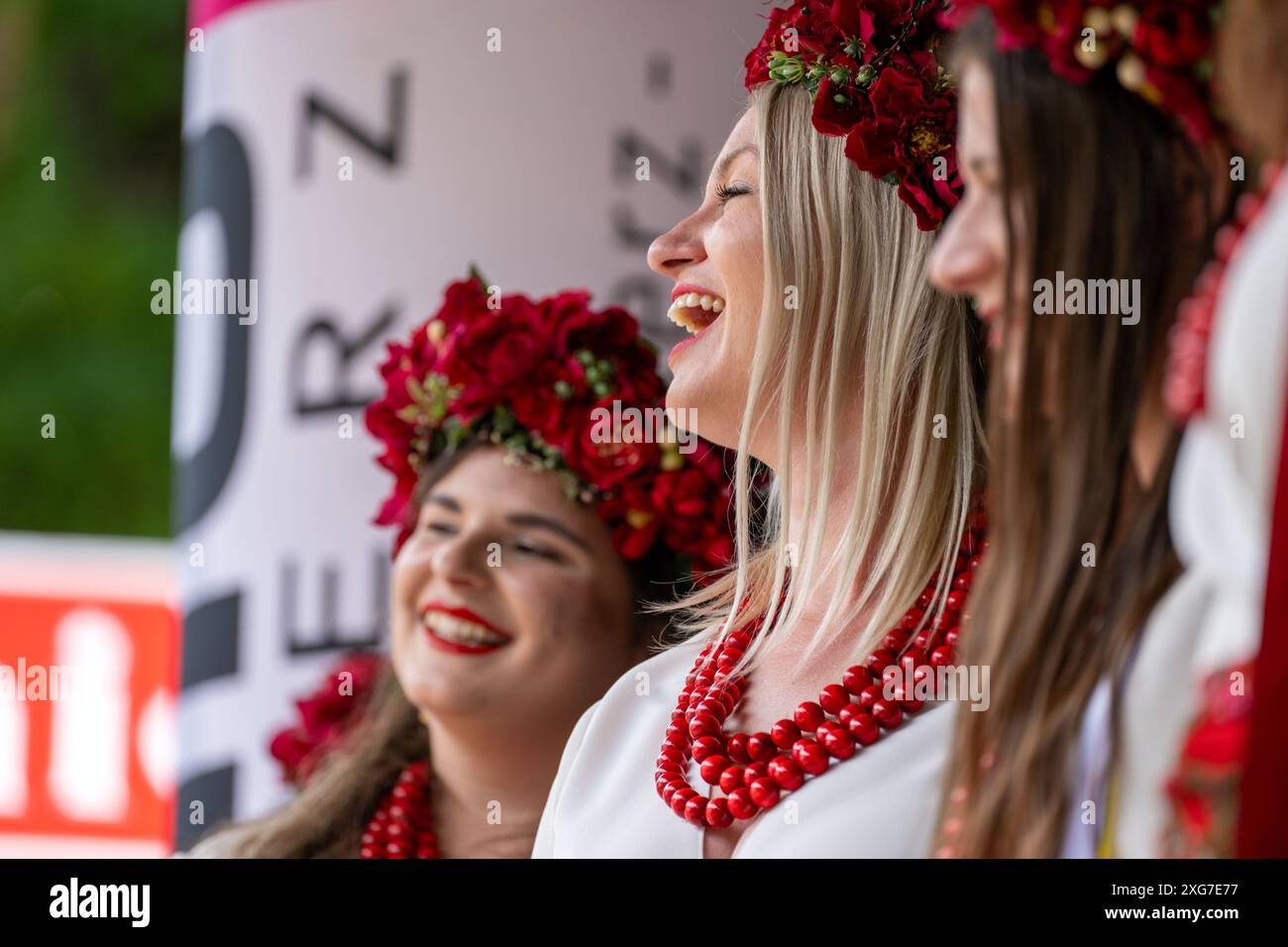07 July 2024, Bavaria, Wunsiedel: With red flower wreaths and white ...