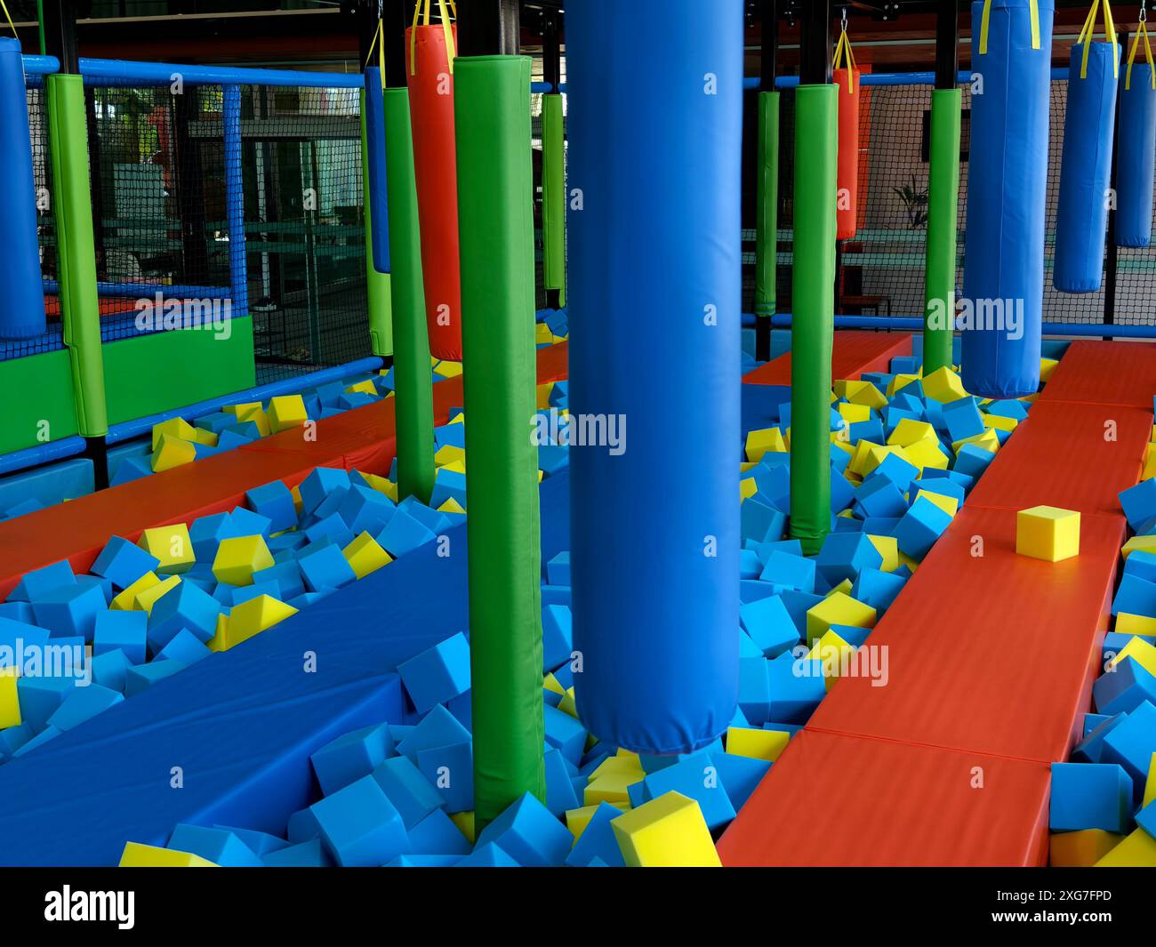 Trampoline park has blue and yellow foam cubes for kids fun Stock Photo ...