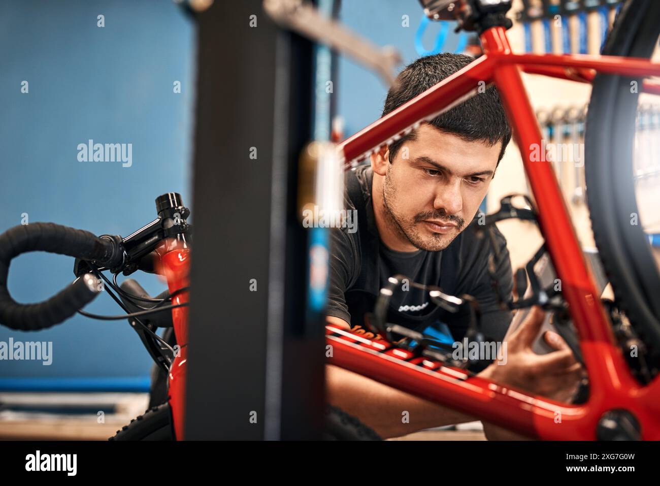Bike repair, tablet and transport with man in workshop for frame ...