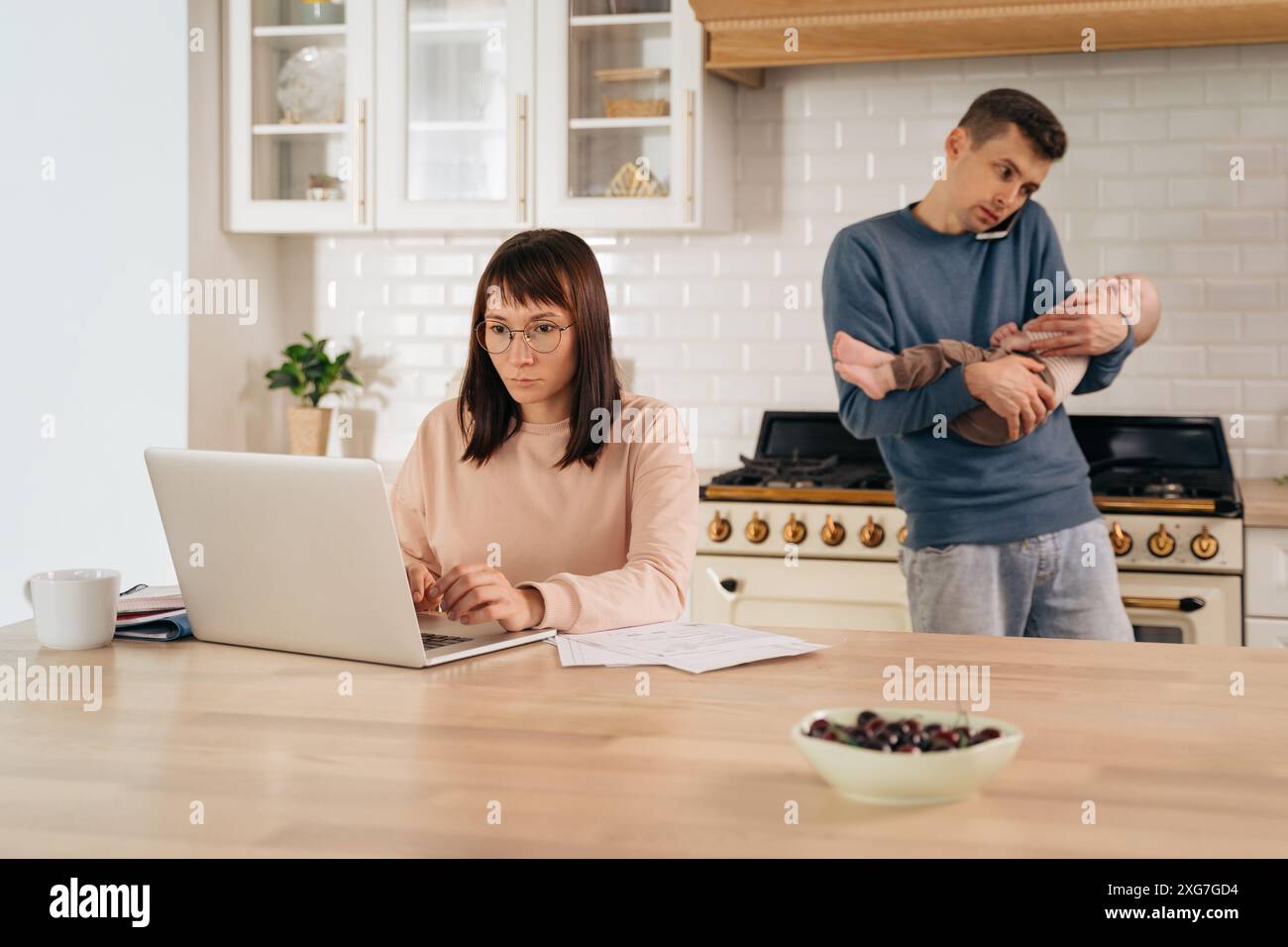 Paternity leave and gender family roles concept. Young business woman using laptop for remote ...