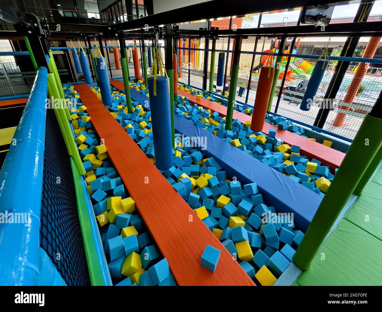 Trampoline park has blue and yellow foam cubes for kids fun Stock Photo ...