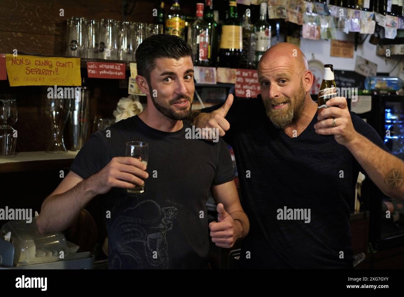 Portrait of wo friendly bar men at a small bácaro (wine bar) Osteria ...