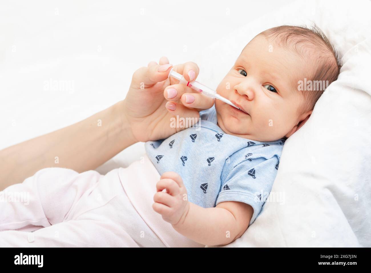 Mother feeding newborn baby with Vitamin K to prevent Vitamin K ...