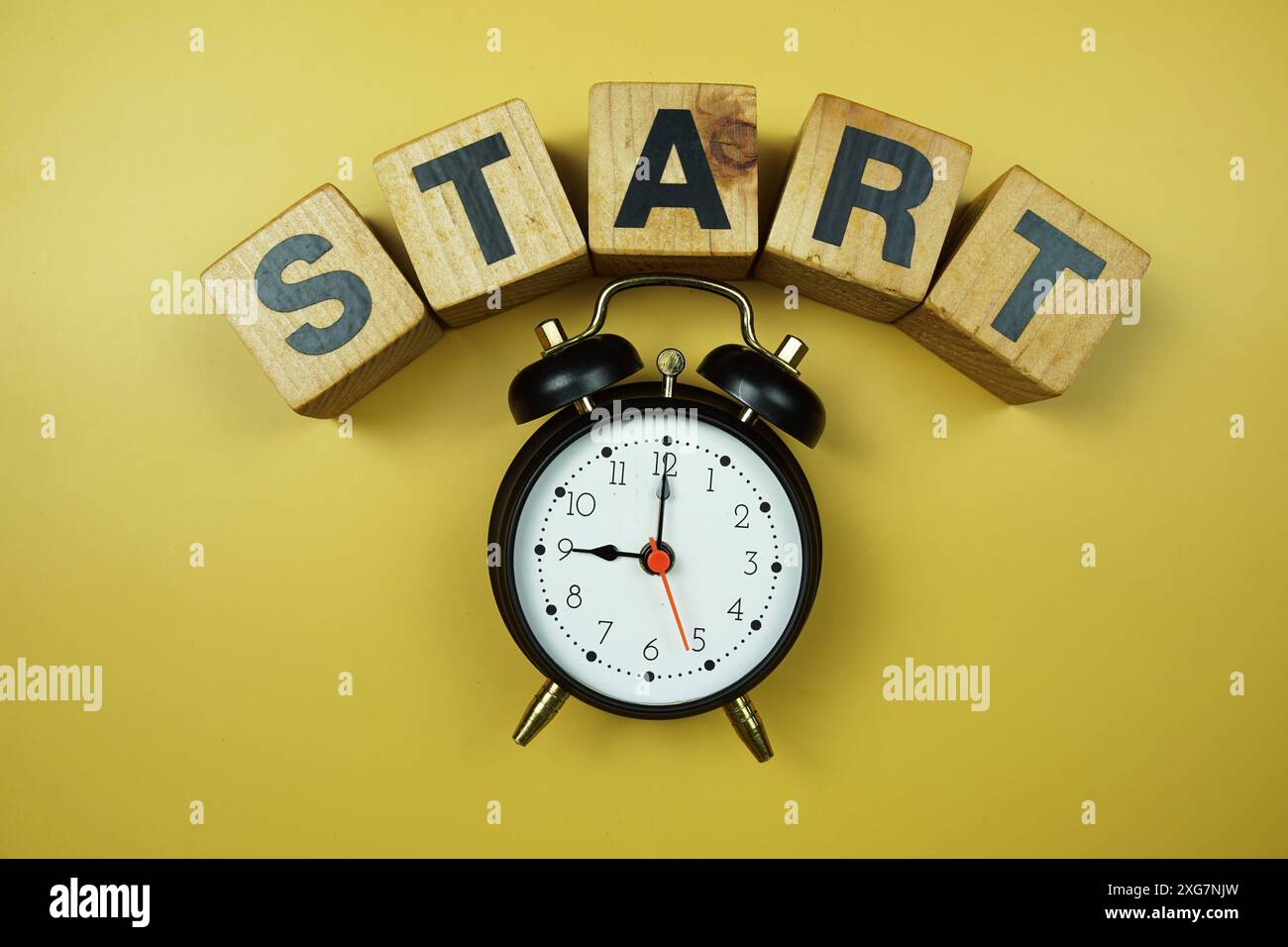 Start word and alarm clock top view on yellow background Stock Photo ...