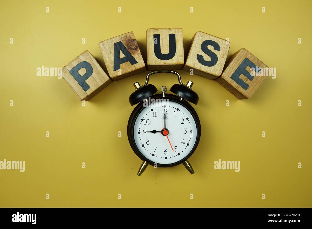 Pause word and alarm clock top view on yellow background Stock Photo ...