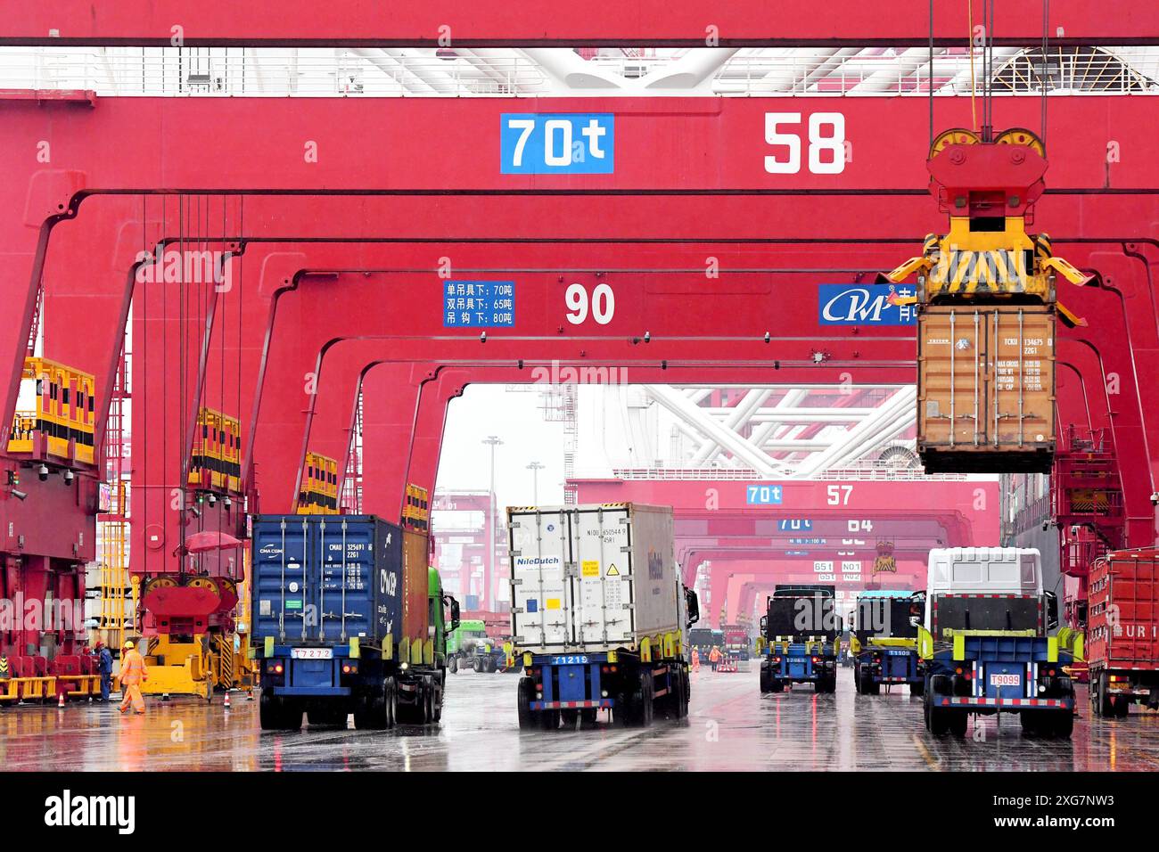 QINGDAO, CHINA - JULY 7, 2024 - Cargo ships load and unload containers at the foreign trade ...