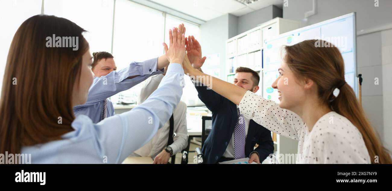 Witty colleagues performing high five gesture, successful profitable ...