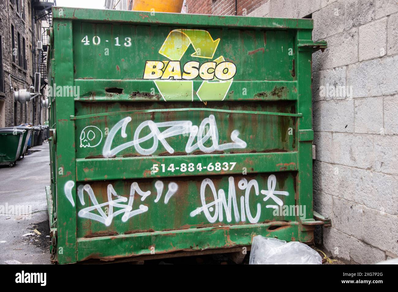 Graffiti tagged on a green dumpster in an alley in downtown Montreal ...
