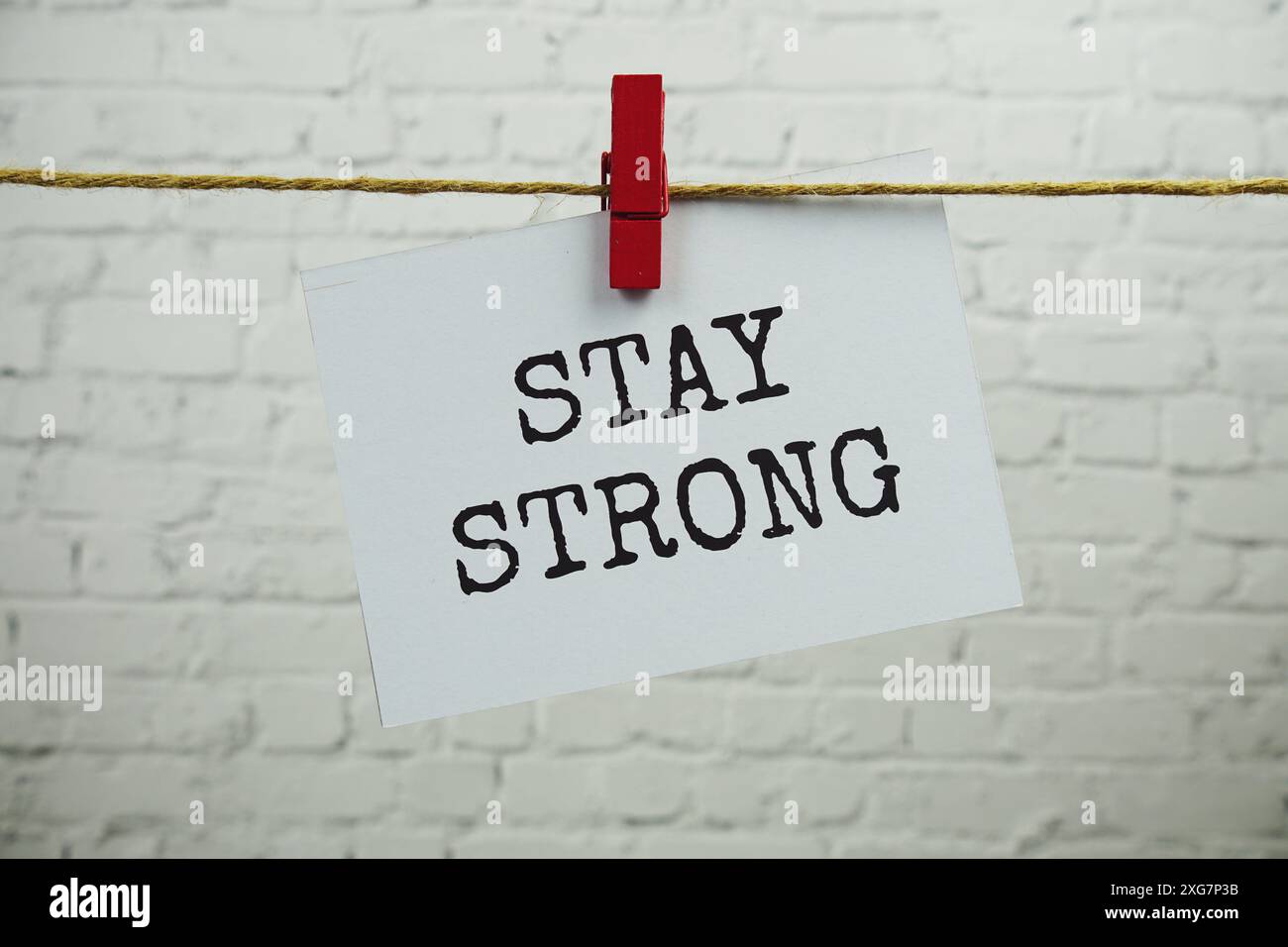 Stay Strong text on paper card hanging on the wall with Clothespins ...