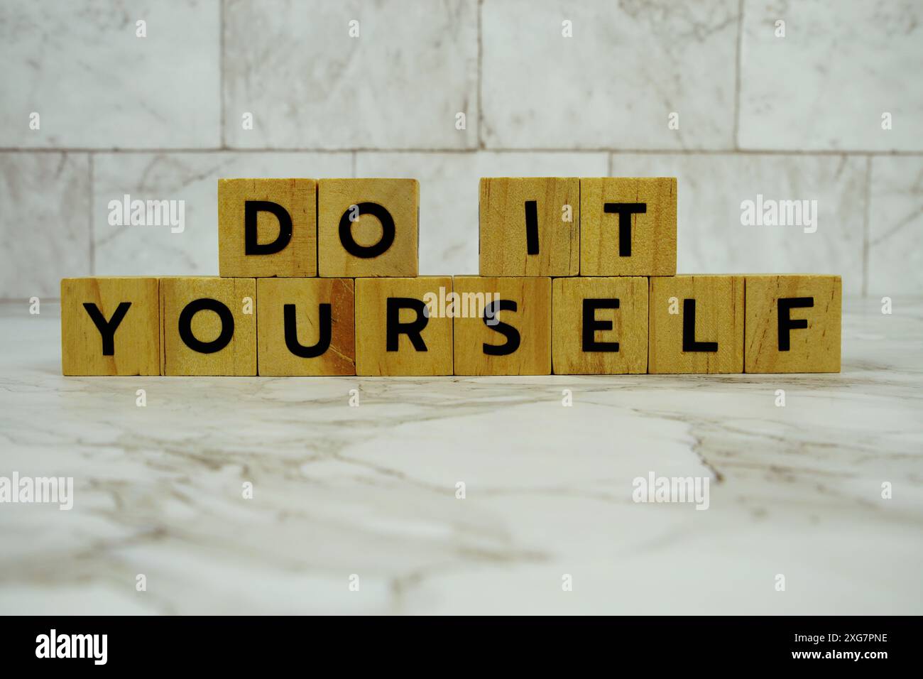 Do It Yourself with wooden blocks alphabet letters on marble background ...