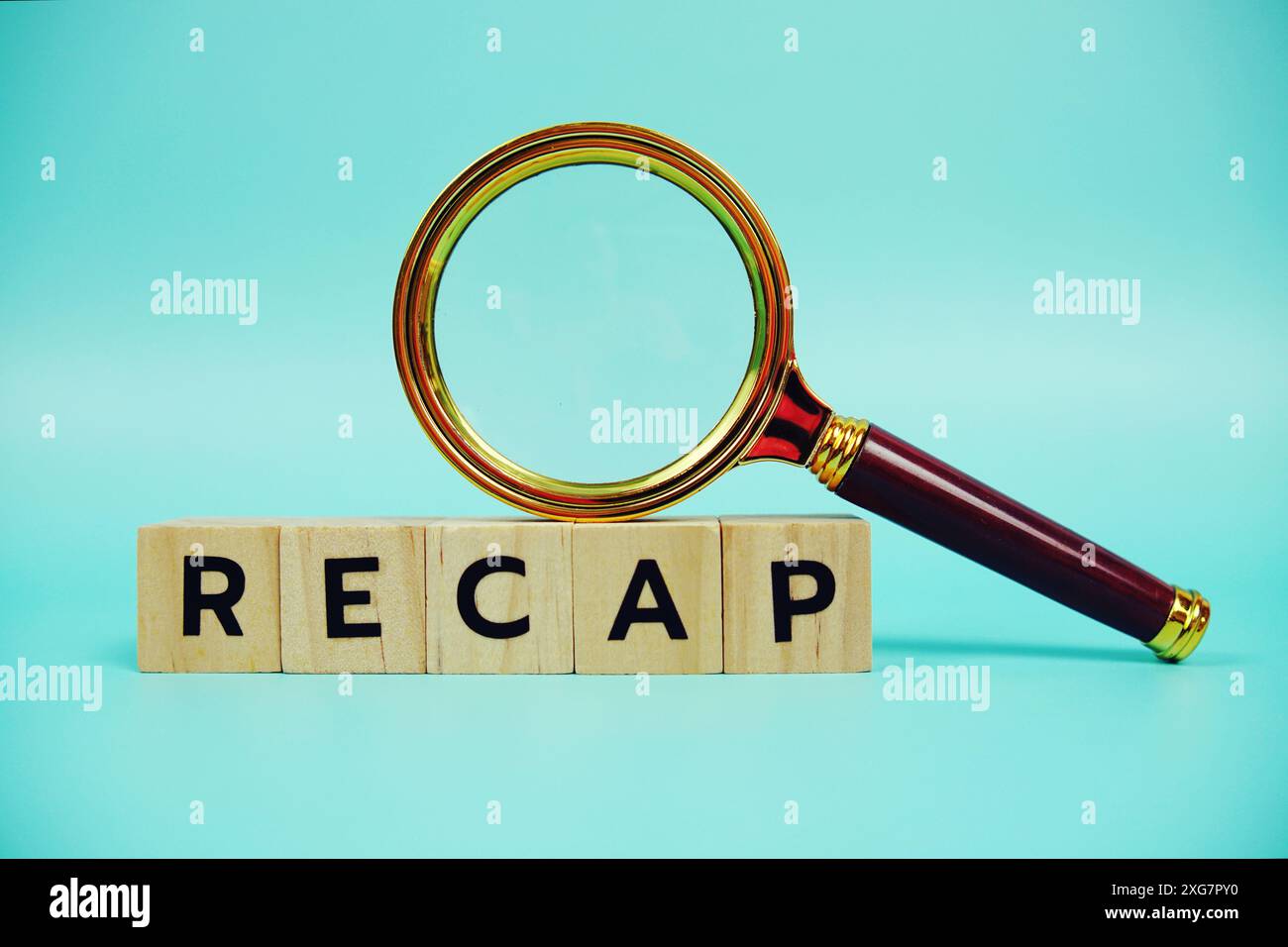 Recap with wooden blocks alphabet letters and Magnifying glass on blue ...