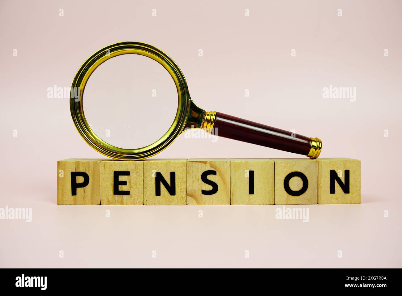 Pension with wooden blocks alphabet letters and Magnifying glass on ...