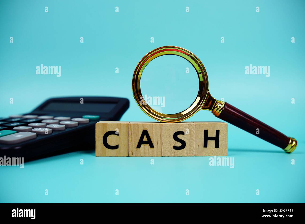 Cash with wooden blocks alphabet letters and Magnifying glass and ...