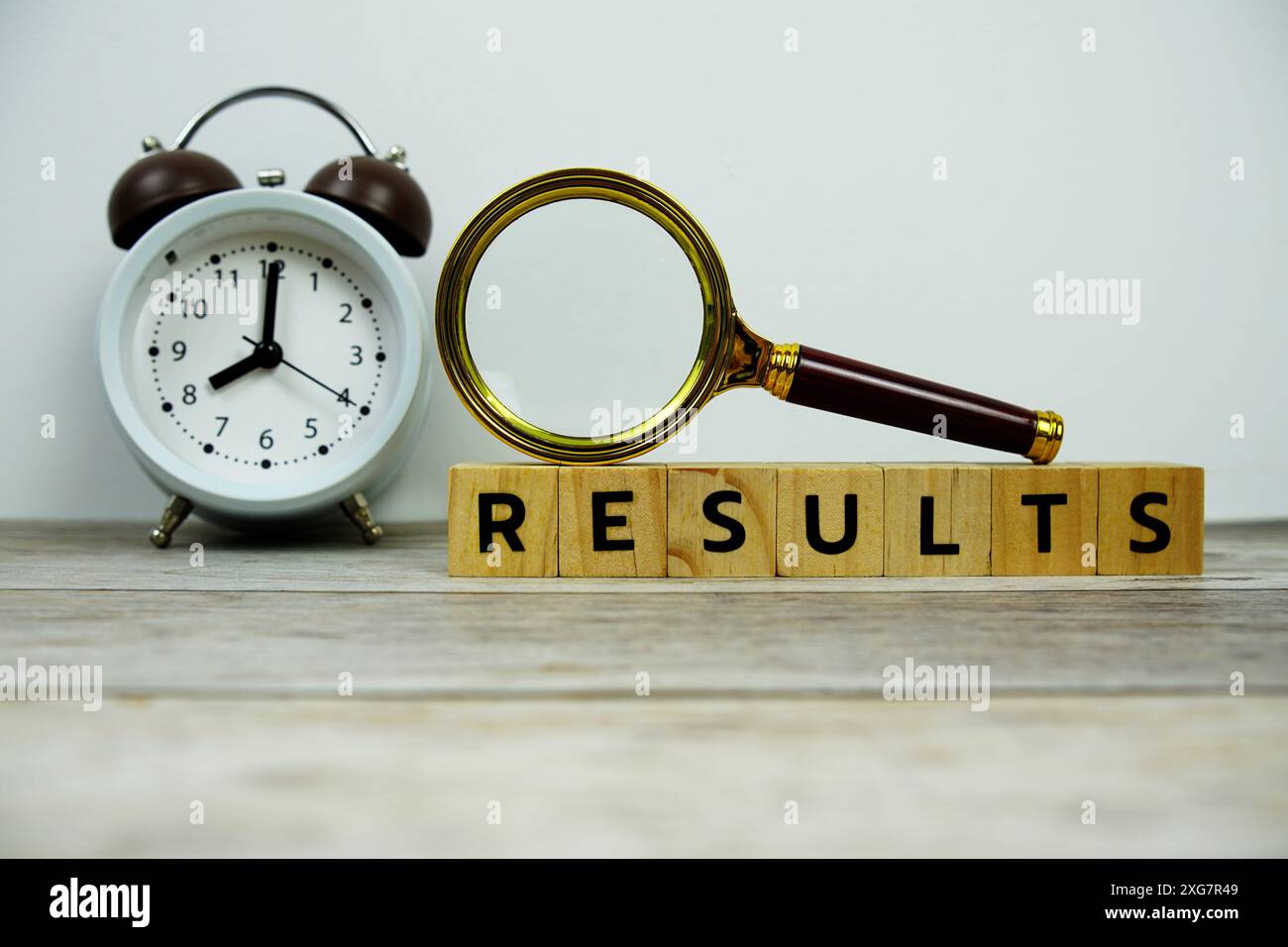 Magnifying glass and alarm clock with wooden blocks alphabet letters ...