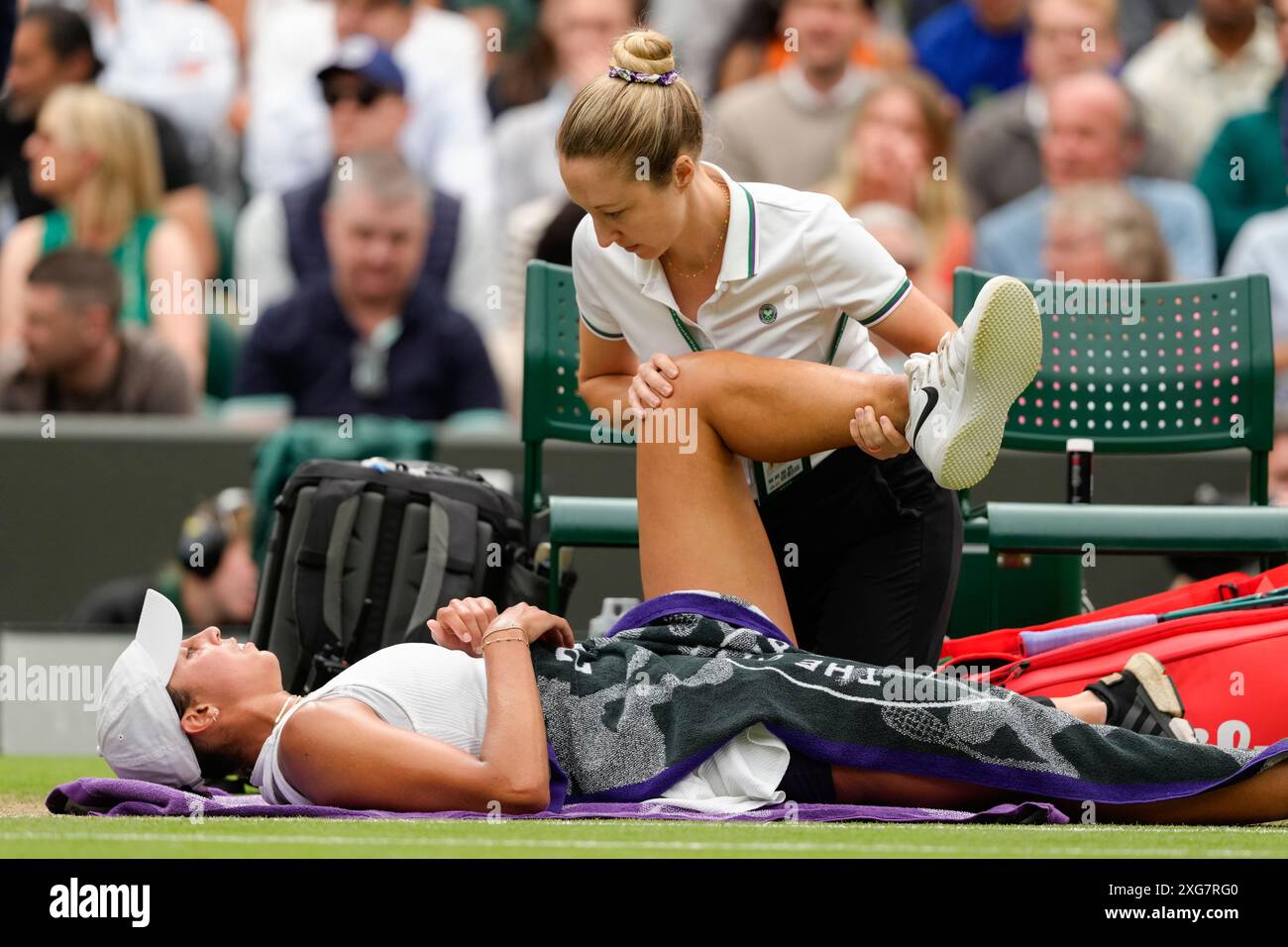 Madison Keys of the United States receives medical attention during her ...