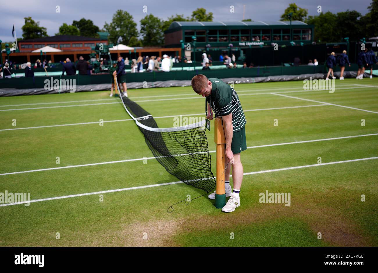 Ground staff set up a net on day seven of the 2024 Wimbledon ...