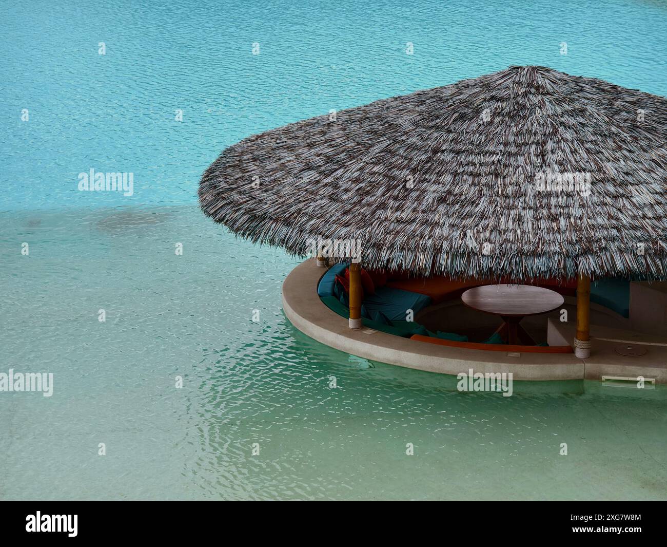 A traditional thatched hut is located within a swimming pool Stock ...