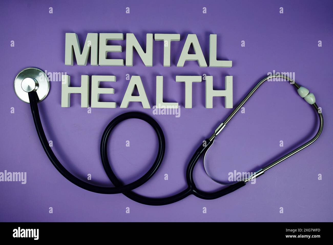 Mental Health alphabet letters and stethoscope on purple background ...