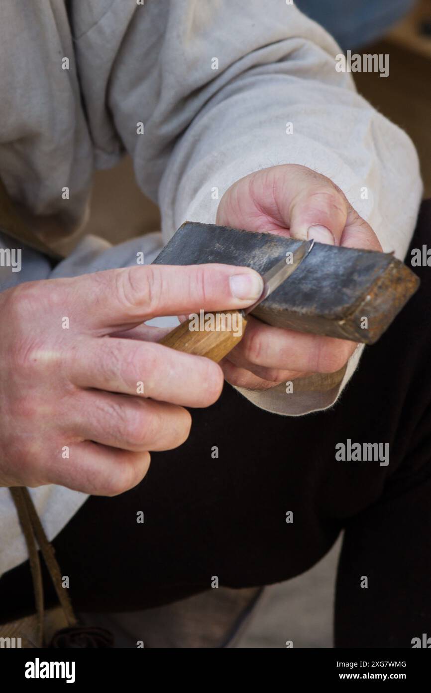 sharpening knife with a stone Stock Photo - Alamy